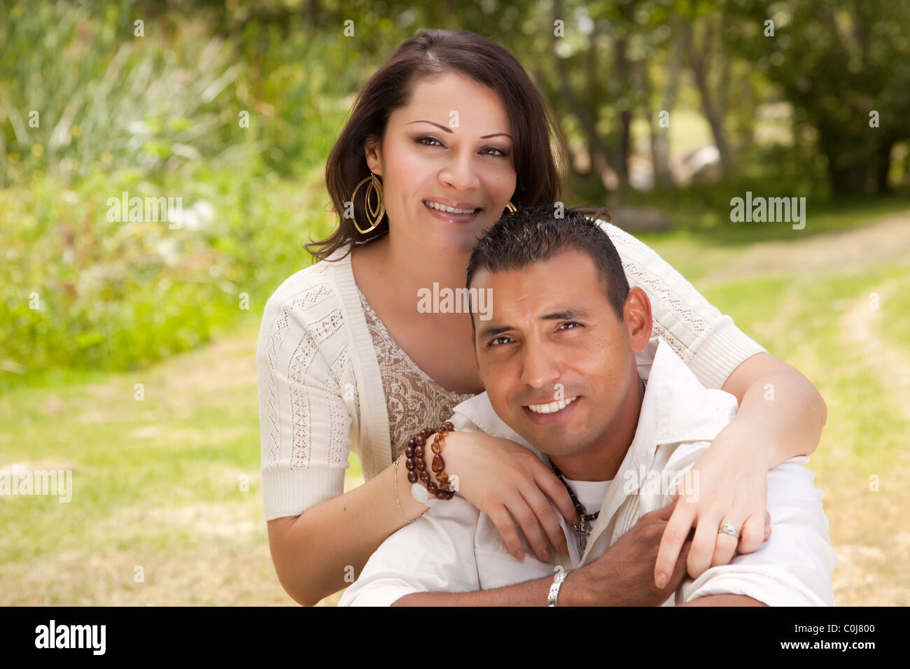Young Happy Hispanic Couple in the Park Stock Photo - Alamy