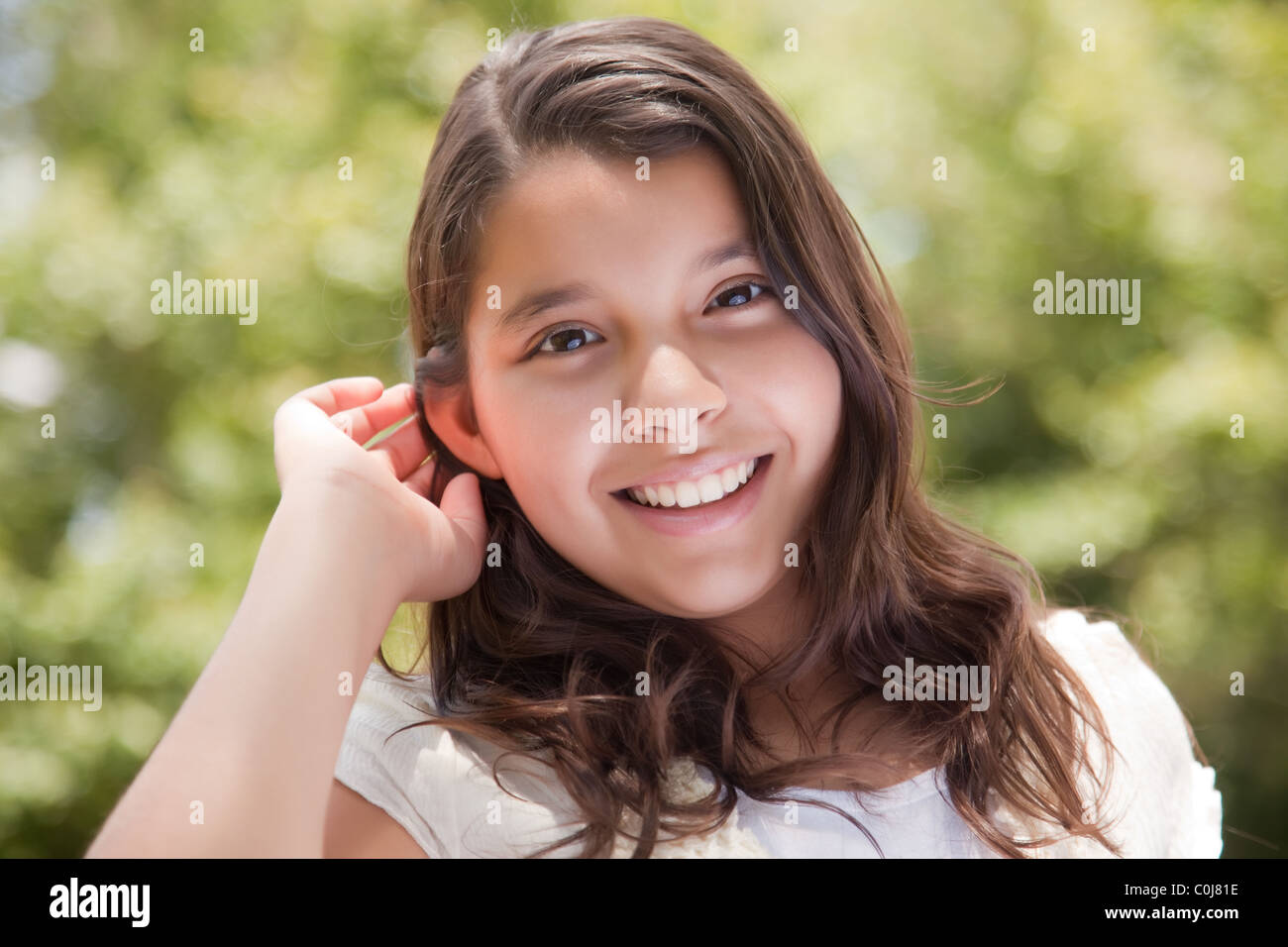Cute Happy Hispanic Girl Portrait in the Park Stock Photo - Alamy