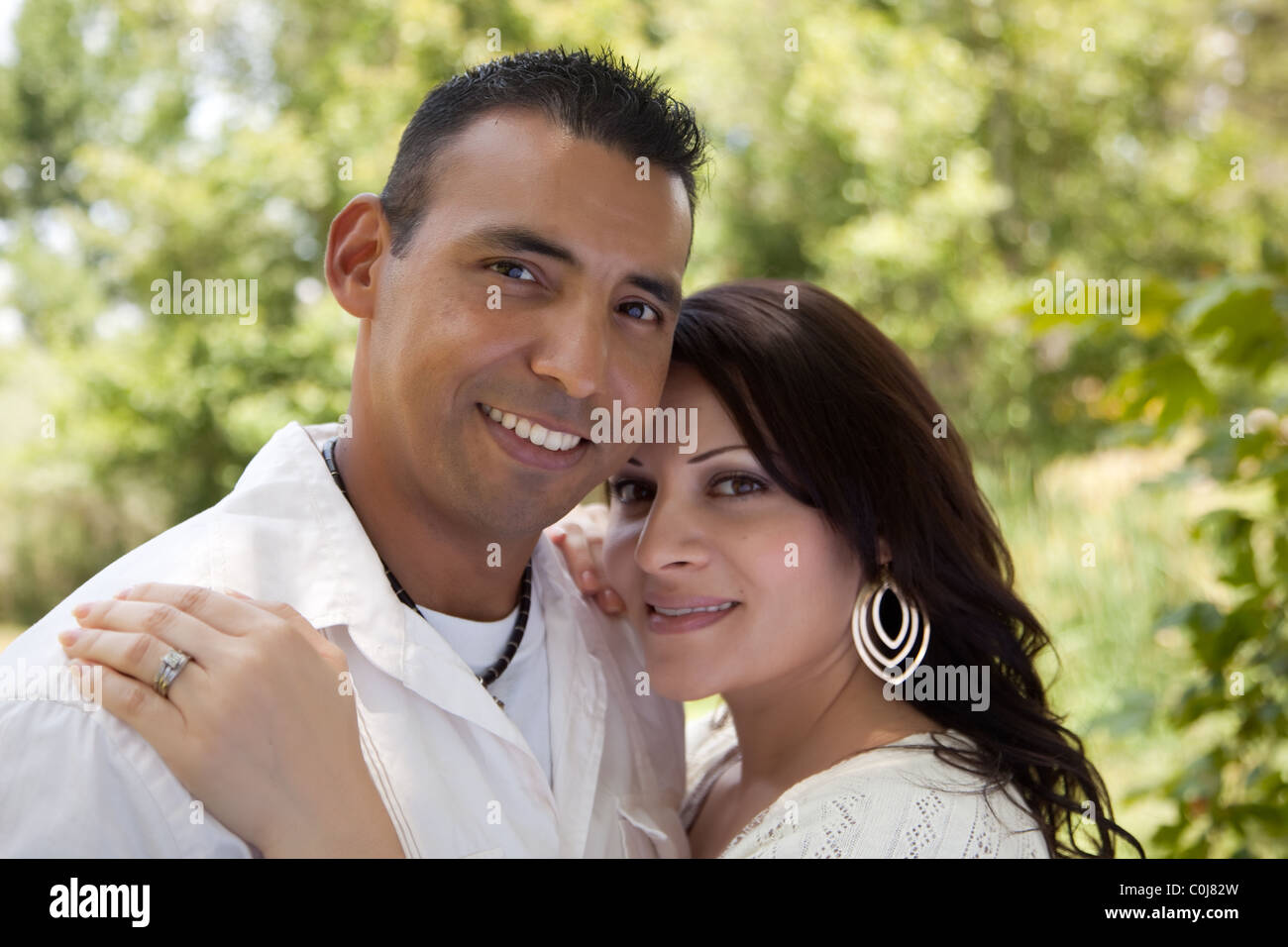 Attractive Hispanic Couple Portrait in the Park Stock Photo - Alamy