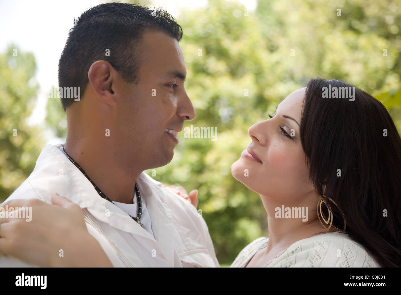 Attractive Hispanic Couple Portrait in the Park Stock Photo - Alamy