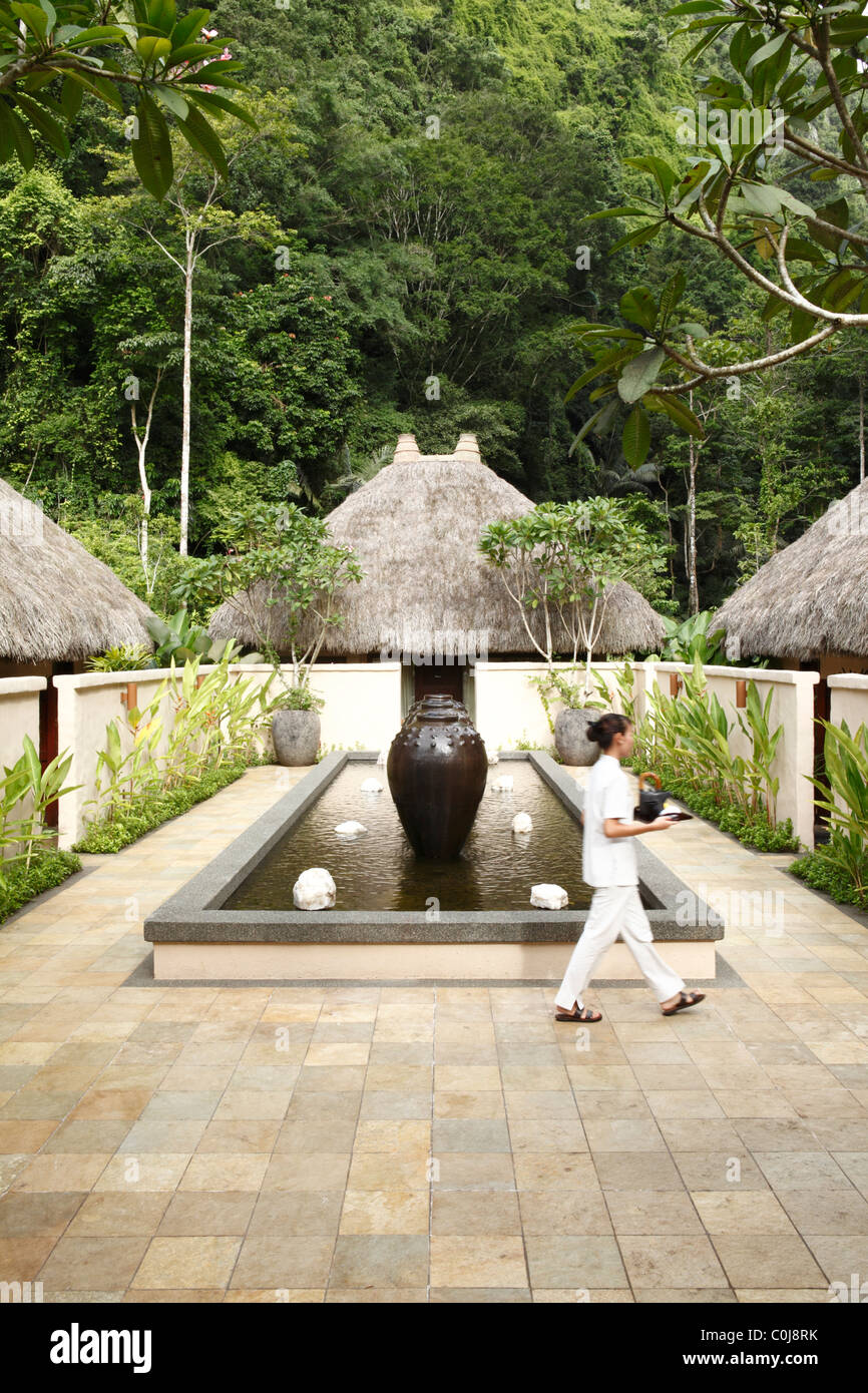 Spa therapist walking through courtyard Stock Photo - Alamy