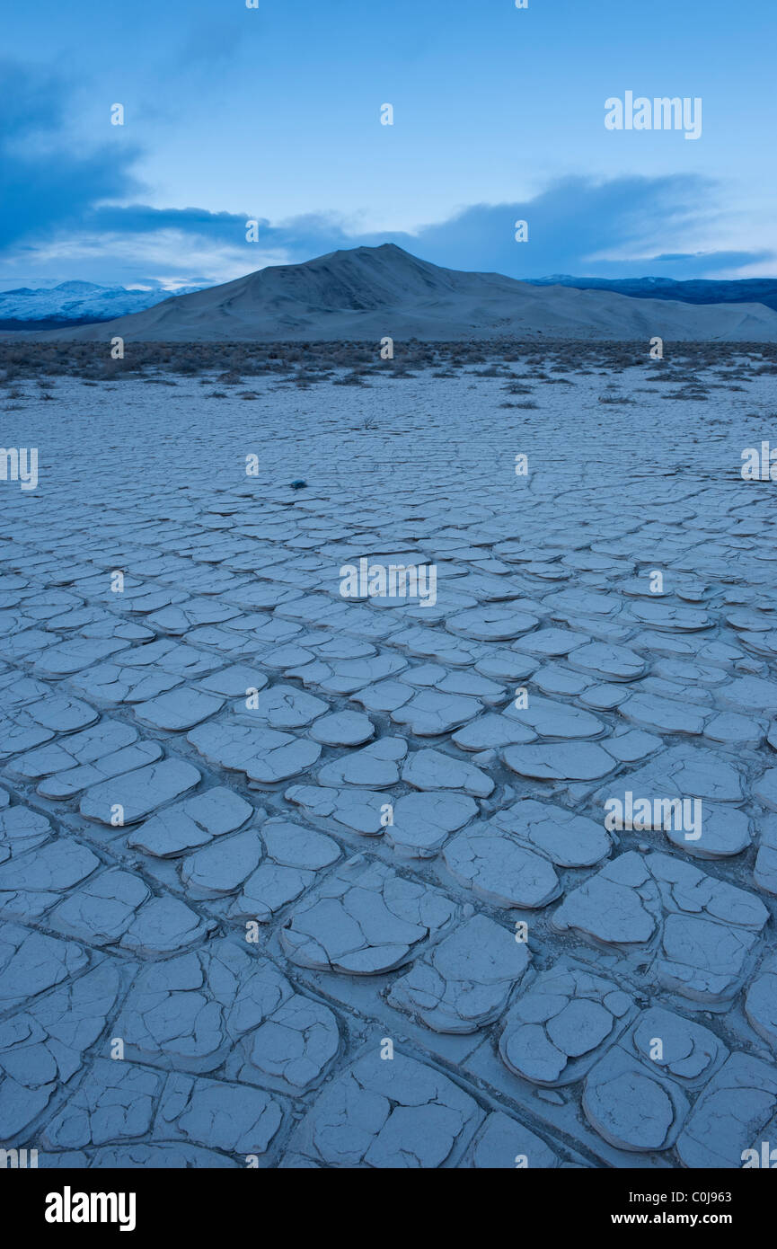 Dried mud flats with Eureka dunes in distance, Death Valley national ...