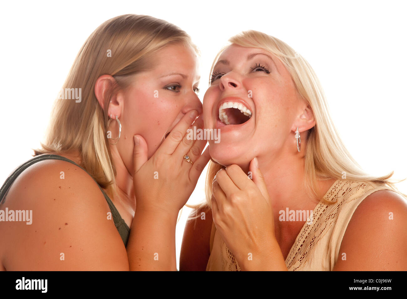 Girl whispering laughing friends ear hi-res stock photography and images - Alamy