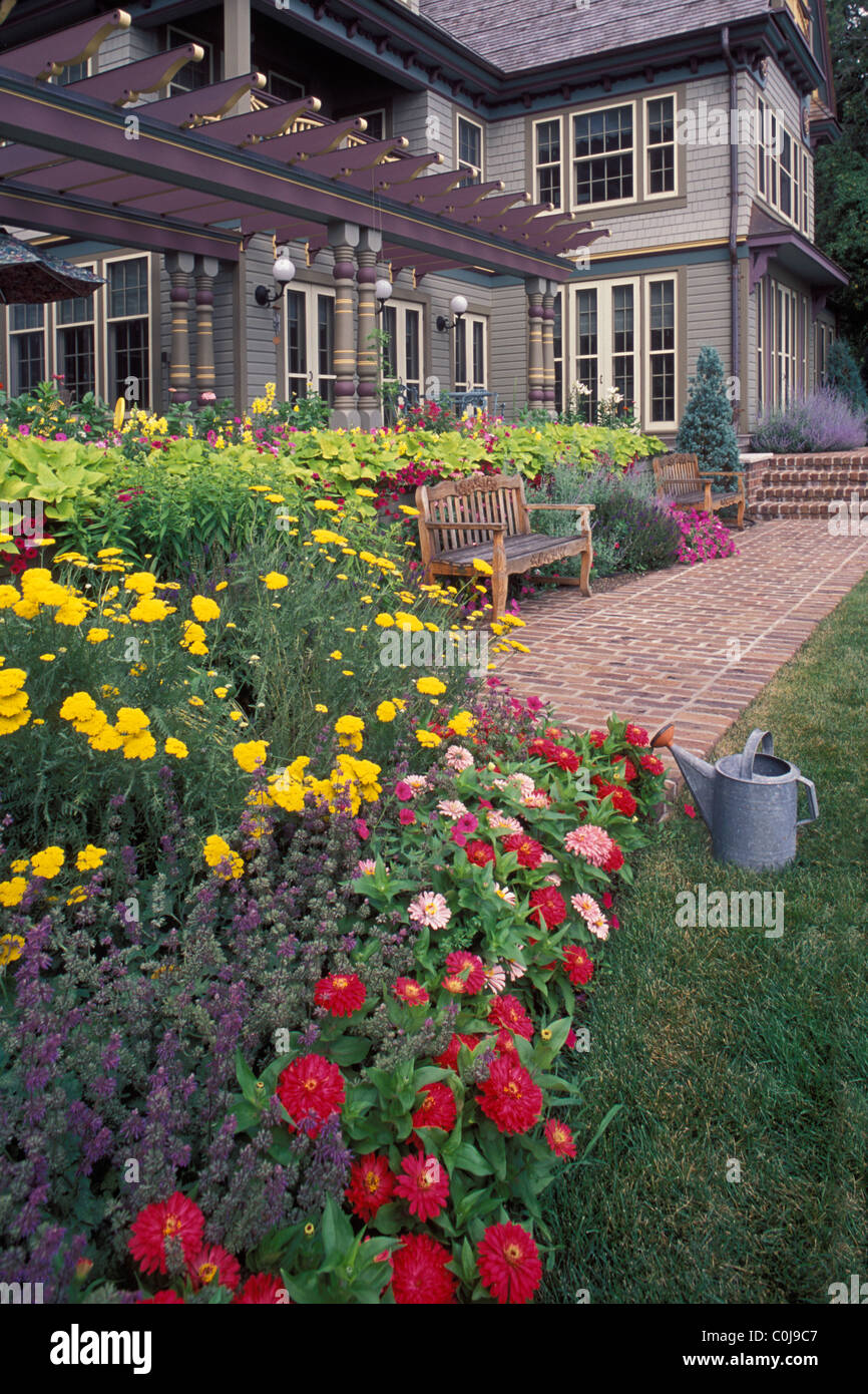 COLORFUL PATIO GARDEN OF AMERICAN HOME IN SUMMER. VICTORIAN "PAINTED ...