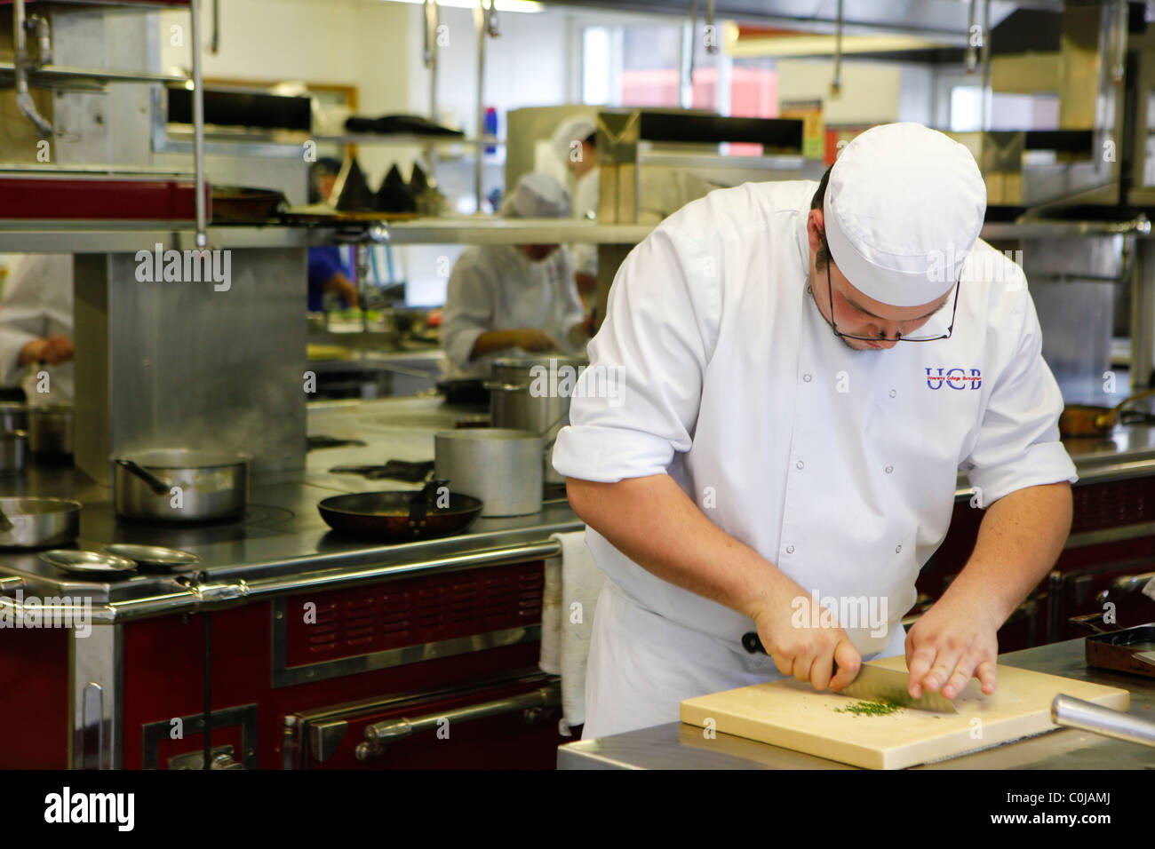 Chefs in a kitchen preparing food at a college for further and higher ...