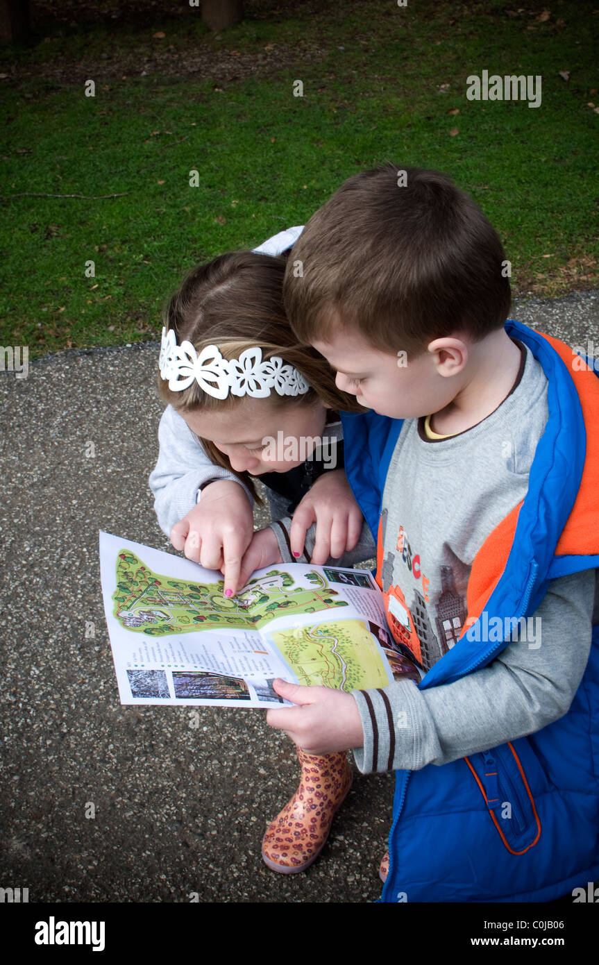 Brother and sister consulting a map mapping hi-res stock photography ...