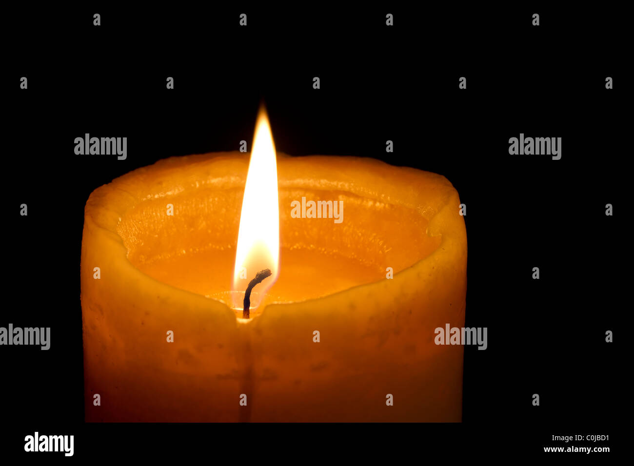 Single glowing candle Stock Photo - Alamy