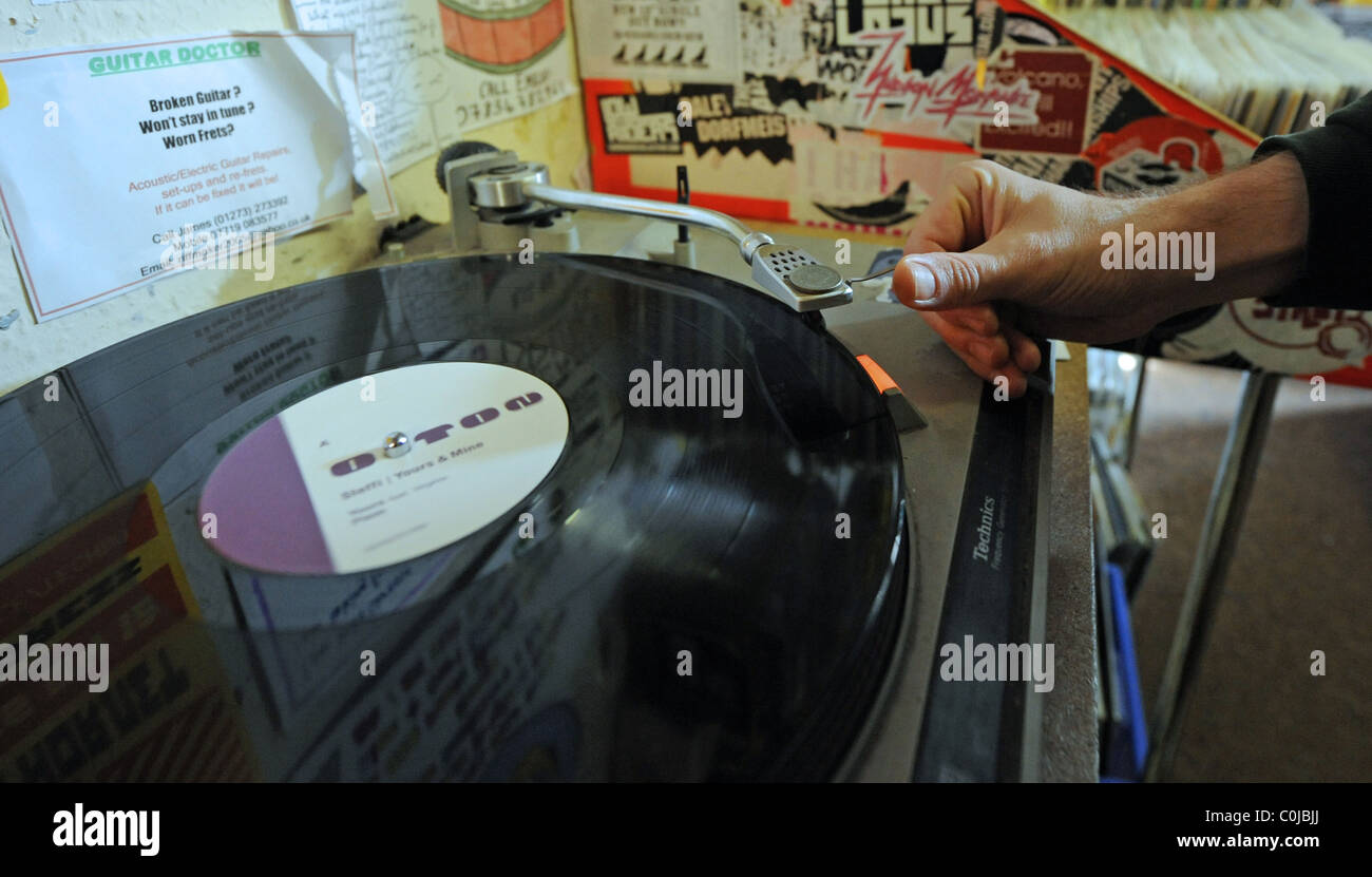 Putting a vinyl record on a turntable record player Stock Photo - Alamy