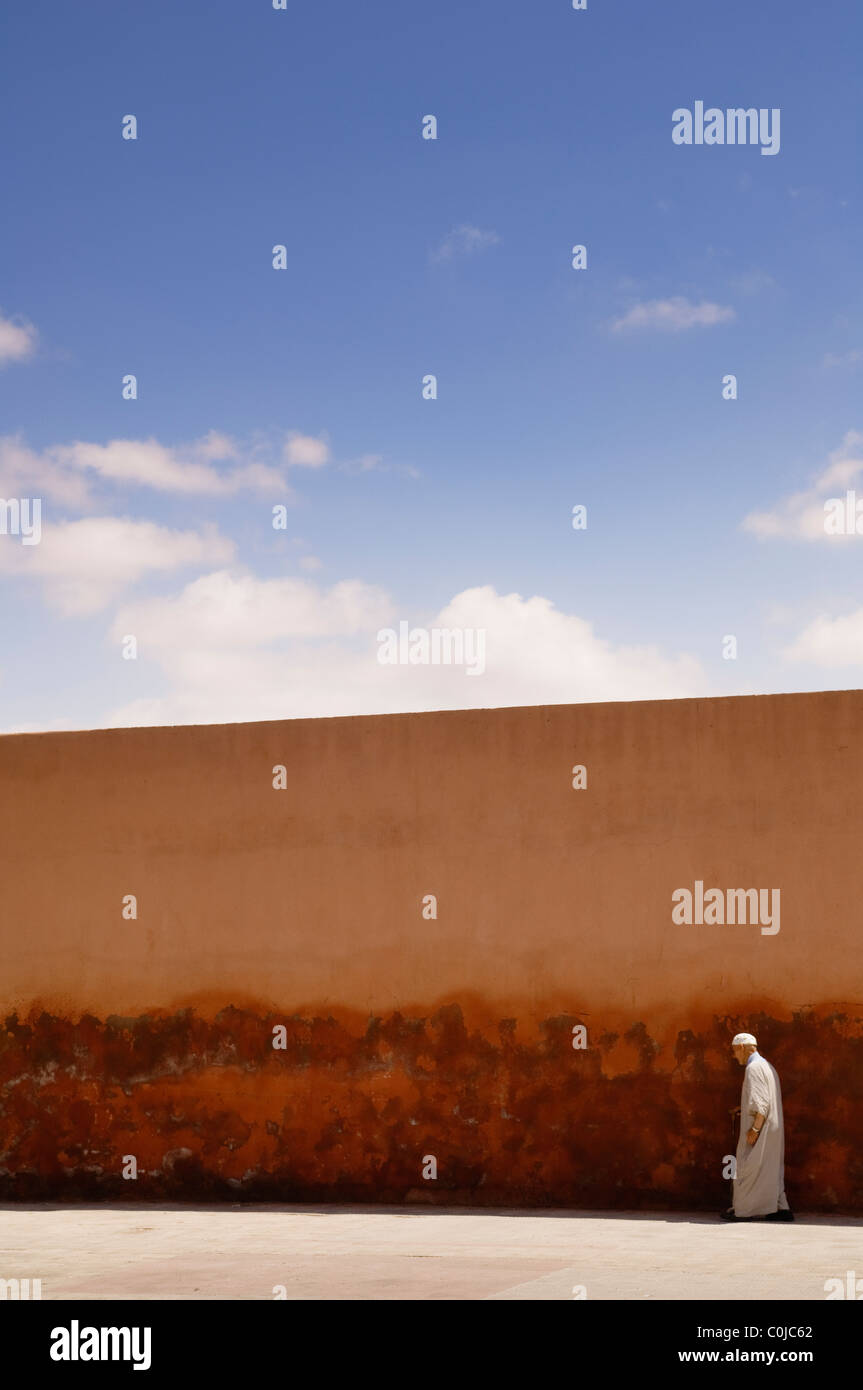 A man walking along the Marrakesh Medina wall Stock Photo - Alamy