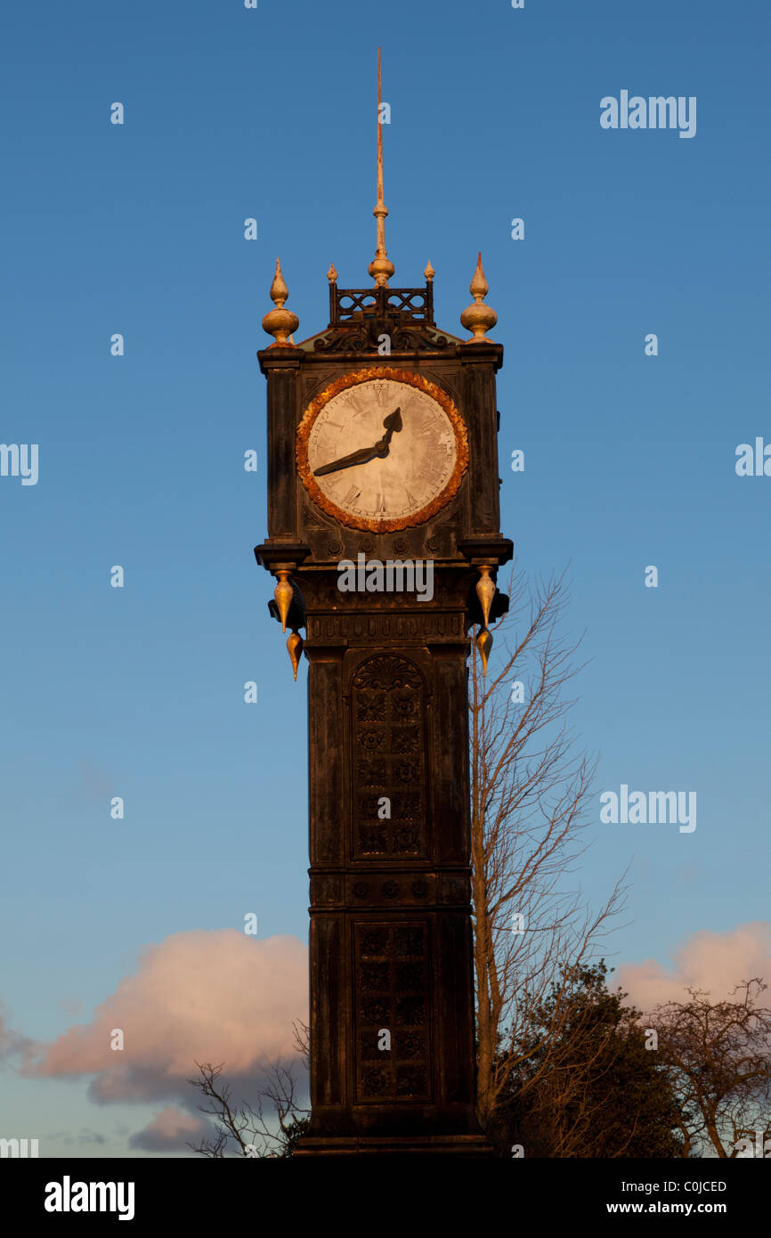 Victorian clock tower in park at twilight Stock Photo - Alamy