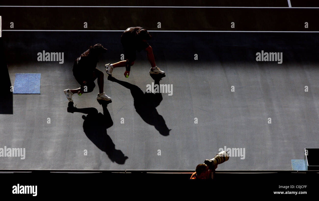 Synchronised ball persons...Ball persons change the end of the tennis ...