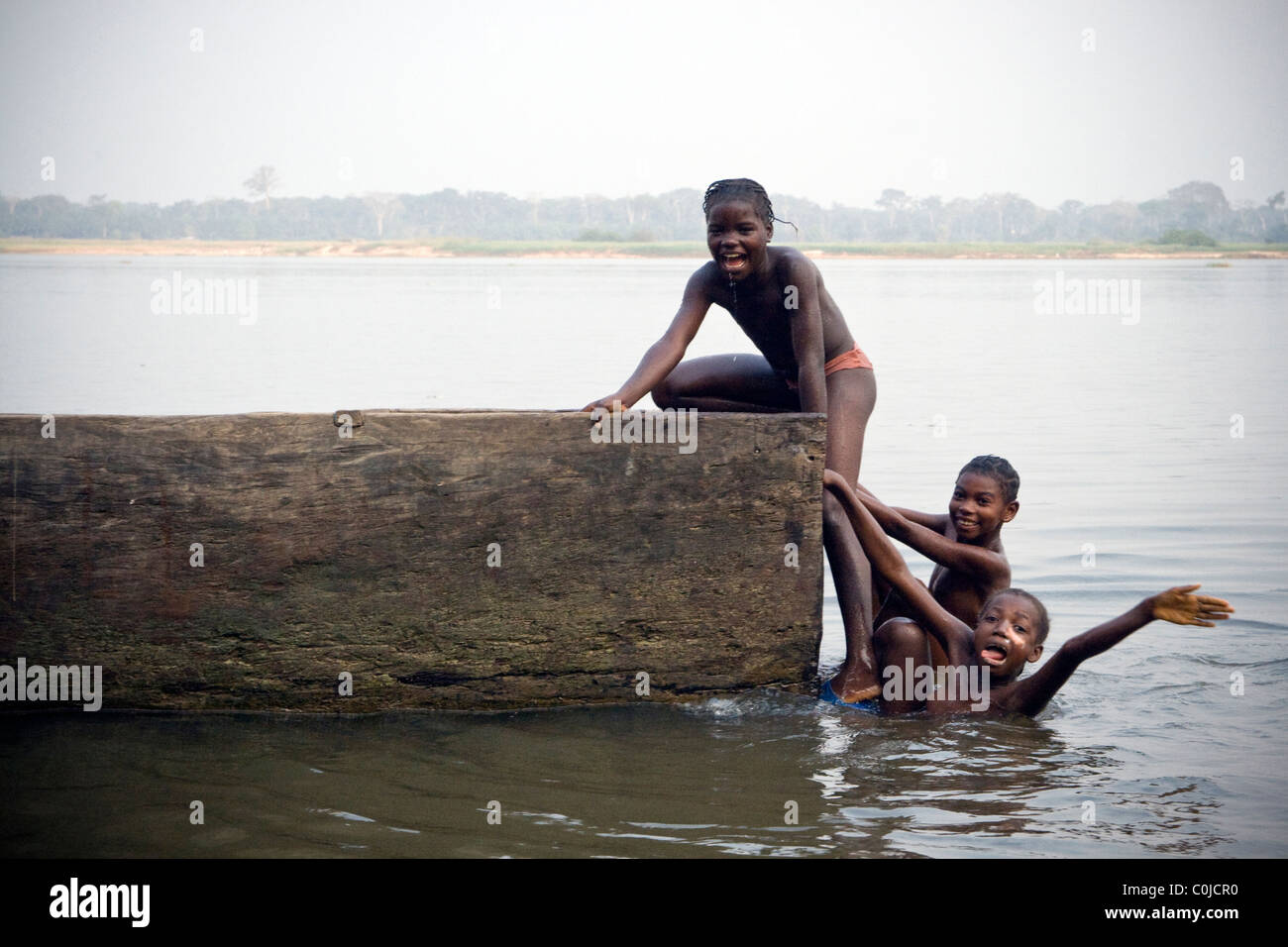 Young people playing on a dugout canoe in Ubangi River,Betou , Republic ...