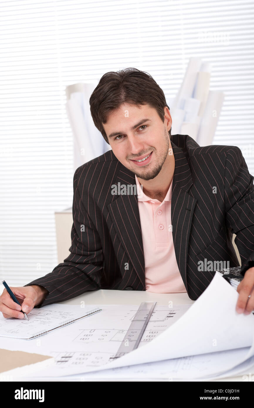 Successful architect man working with plans at office Stock Photo - Alamy