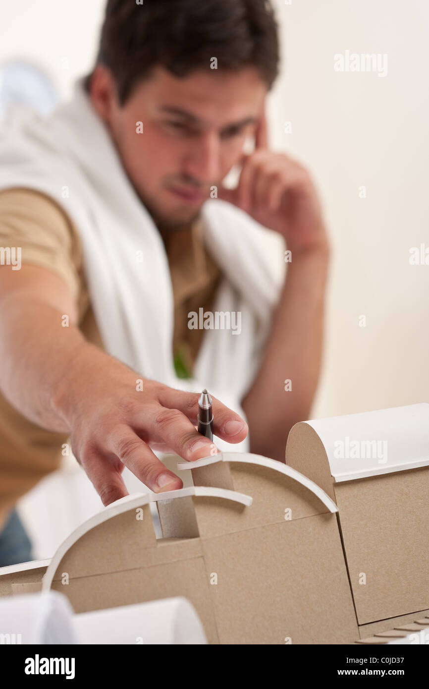 Successful architect man working at office with plans and architectural ...