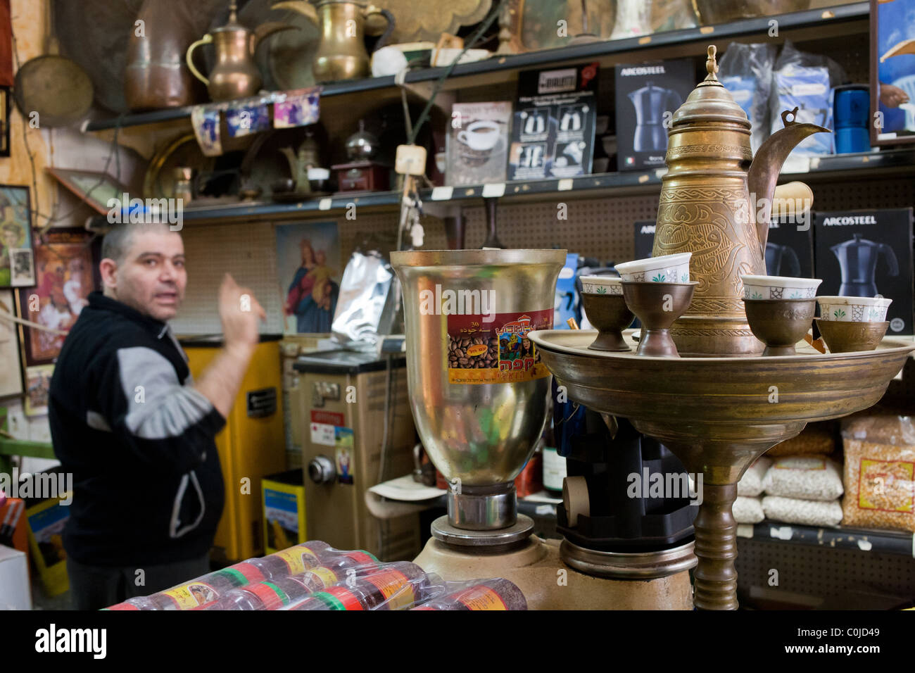 Shopkeeper in coffee shop with traditional Arab kettle and cups Stock ...