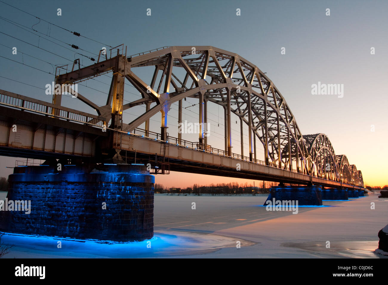 Railway bridge at night in winter close up Stock Photo - Alamy