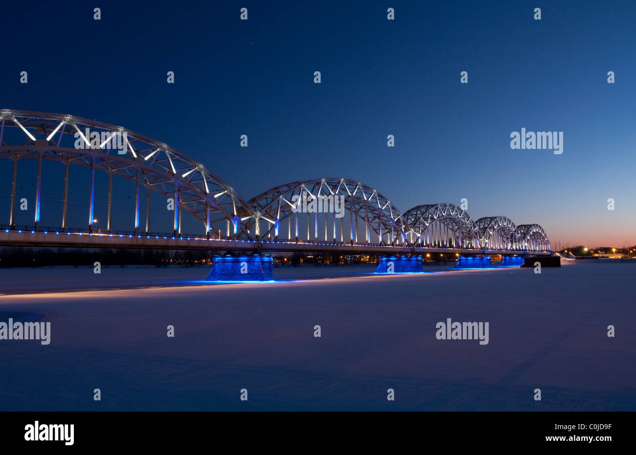 Railway bridge at night in winter close up Stock Photo - Alamy