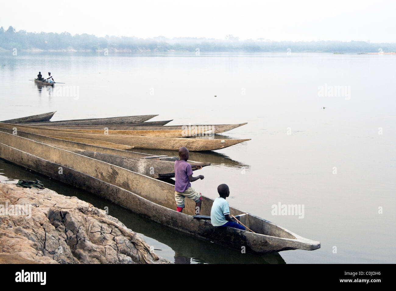 Fishermen on dugout canoe ,Ubangi River ,Betou,Republic of the Congo ...