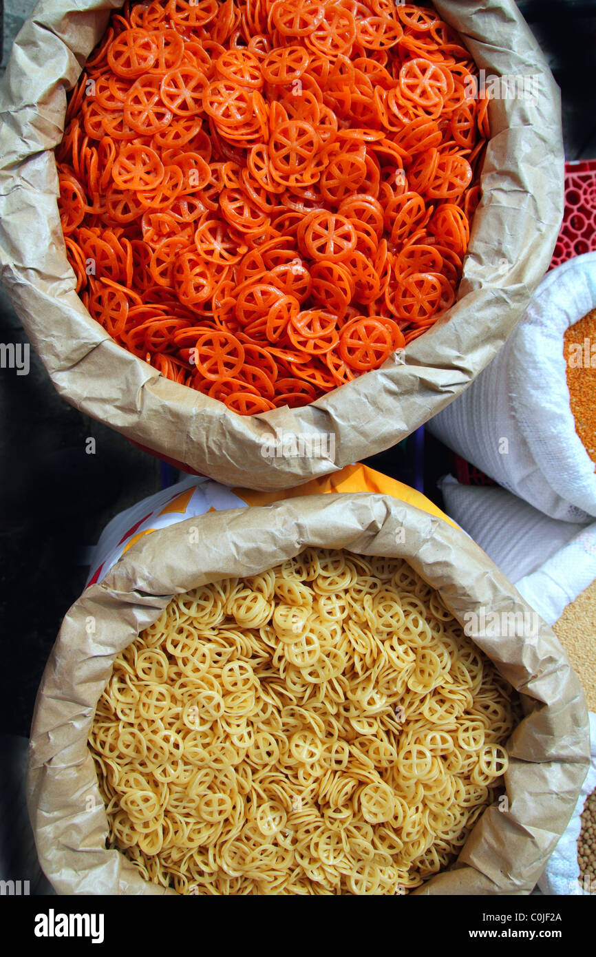 dried round pasta wheels orange in yellow sacks Stock Photo - Alamy