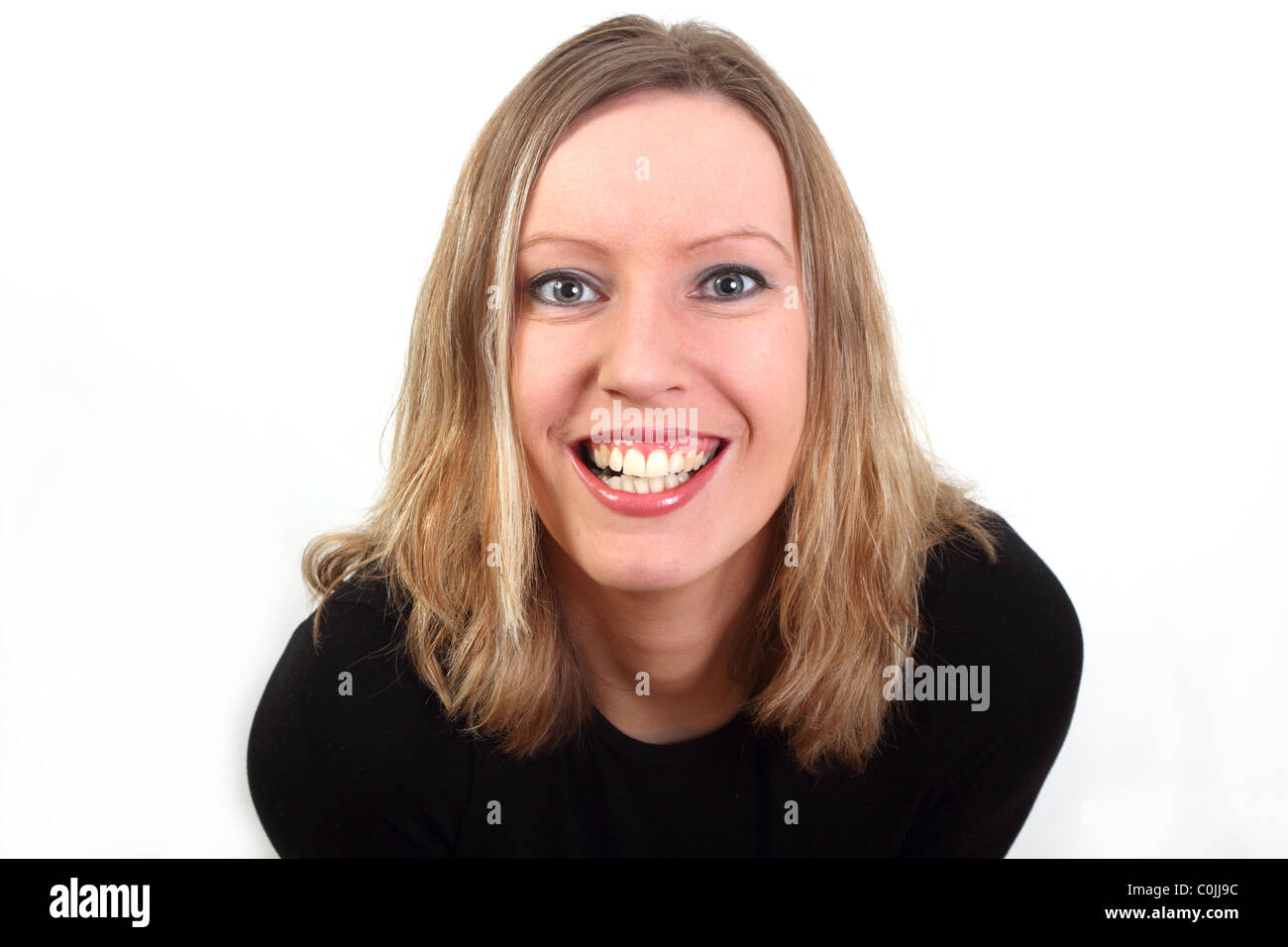 Portrait of young blond woman smiling into camera Stock Photo - Alamy