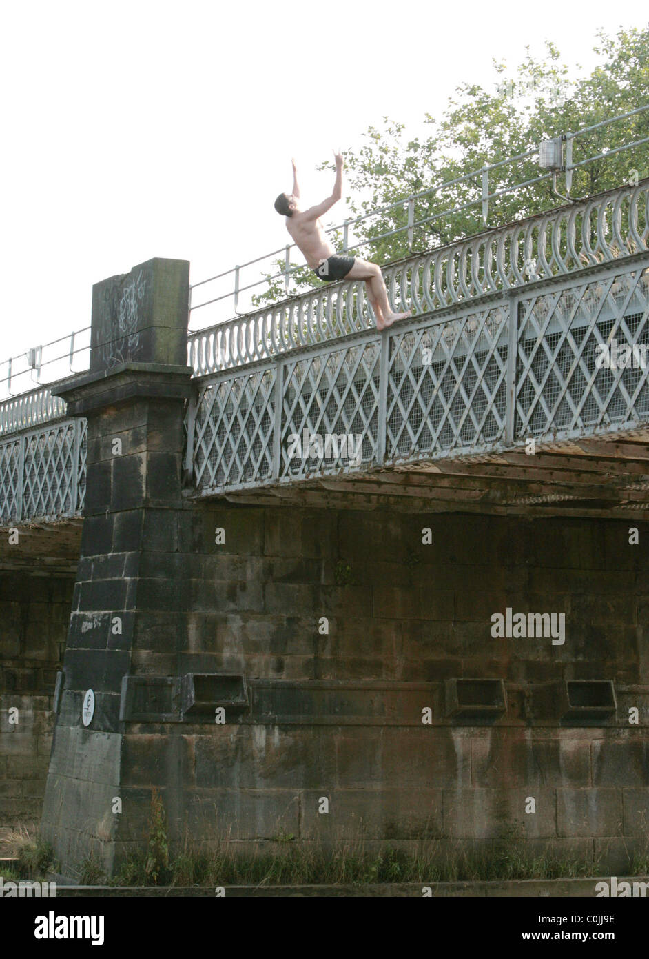 An unknown male backflips from a railway bridge which crosses the River ...