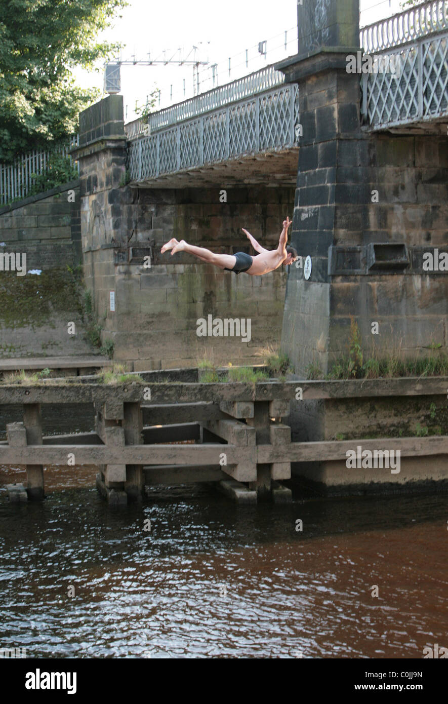 An unknown male backflips from a railway bridge which crosses the River ...