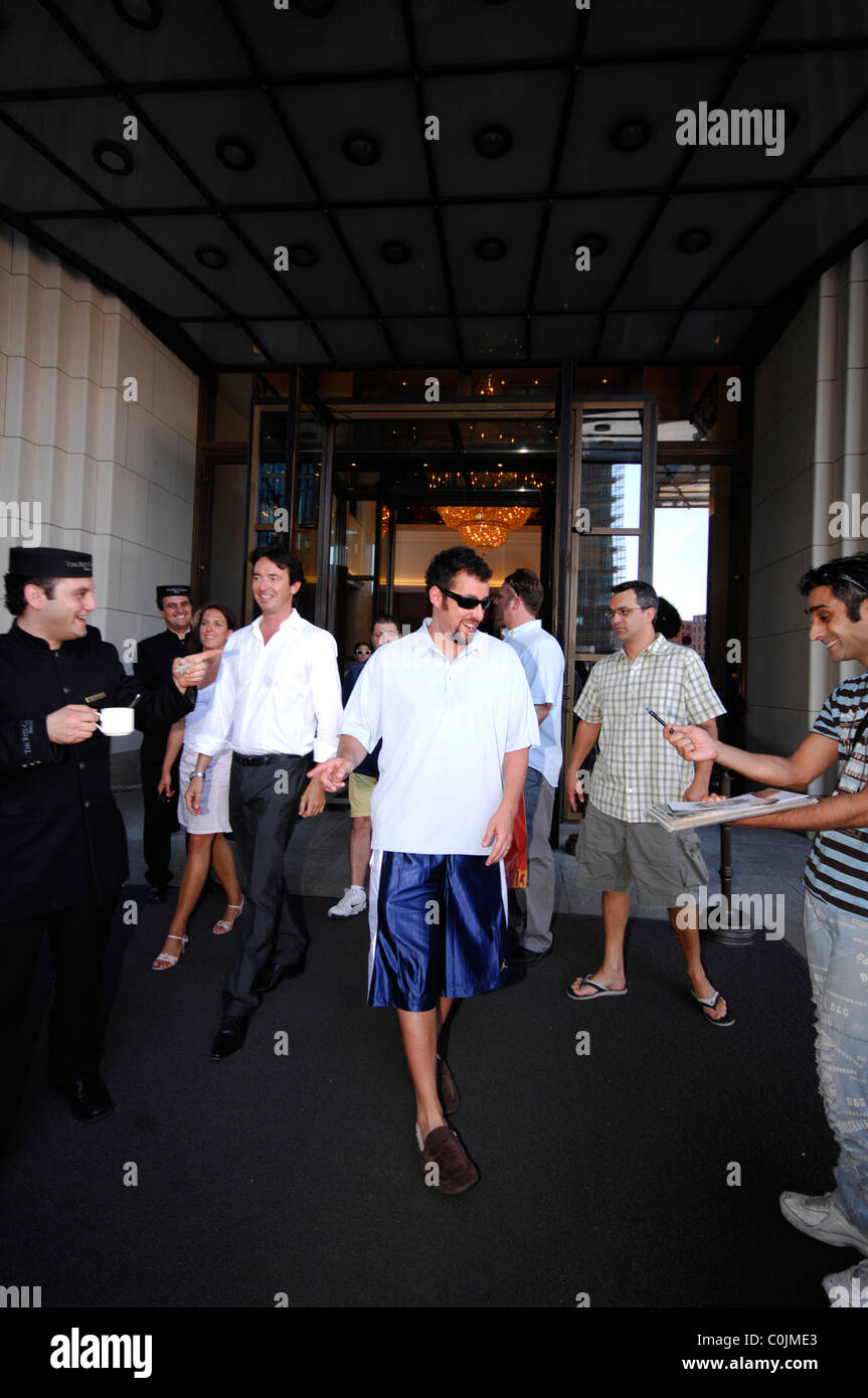 Adam Sandler signing autographs while leaving the Ritz Carlton Hotel ...