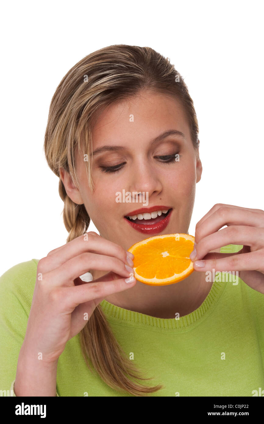 Woman biting orange on white background Stock Photo - Alamy