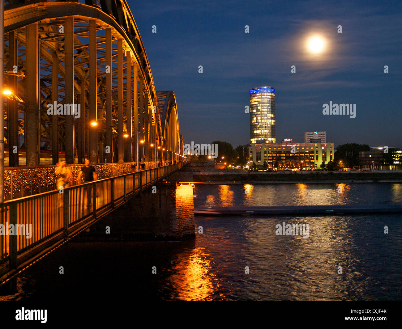 Hohenzollern railway bridge in Cologne at night, with Hyatt hotel in ...