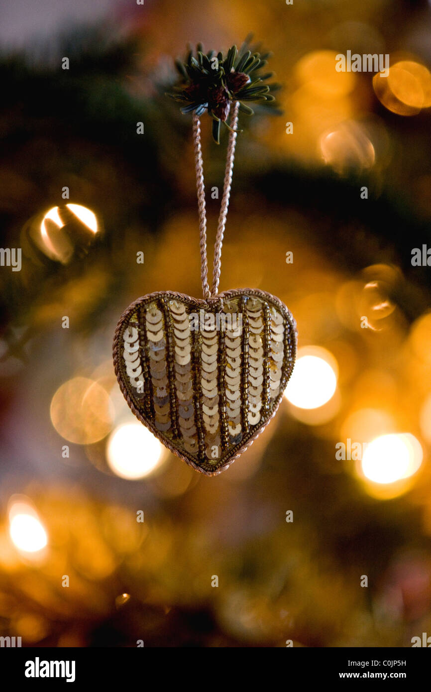 A heart shaped decoration hanging on a Christmas tree Stock Photo - Alamy