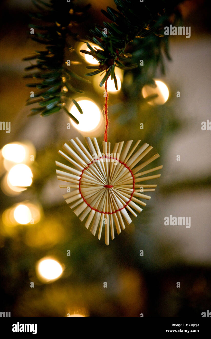 A heart shaped decoration hanging on a Christmas tree Stock Photo - Alamy