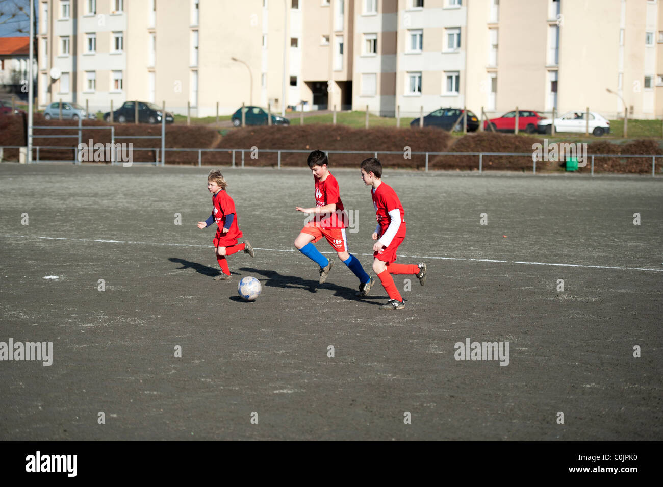 Stock photo of children playing football on a sand pitch in an inner ...