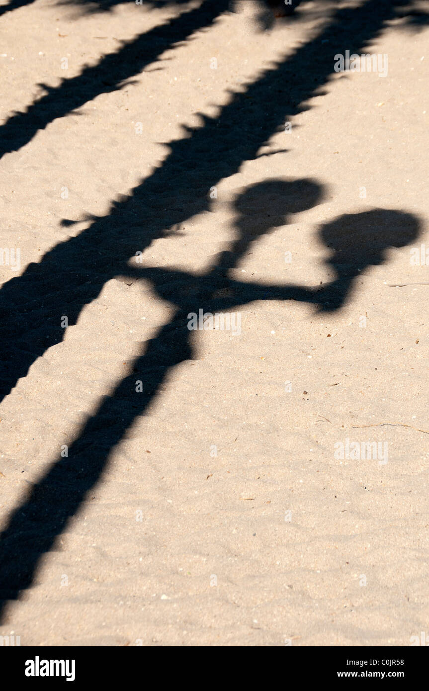 Shadow of public lighting in sand Stock Photo - Alamy