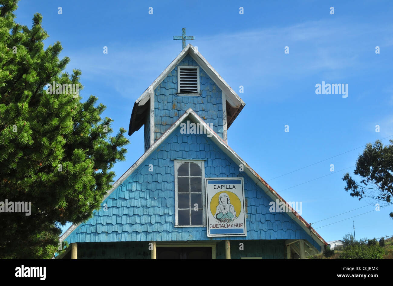 Blue sky blue shingles gable front, bell tower cross and Virgin Mary ...
