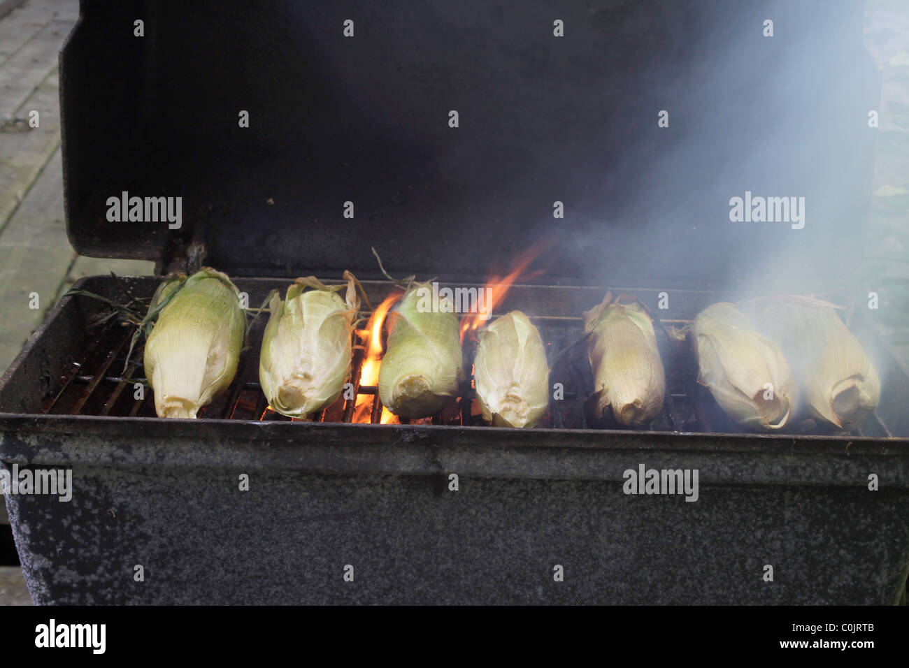 Summer treat, sweet corn ears roasting on the charcoal grill Stock ...