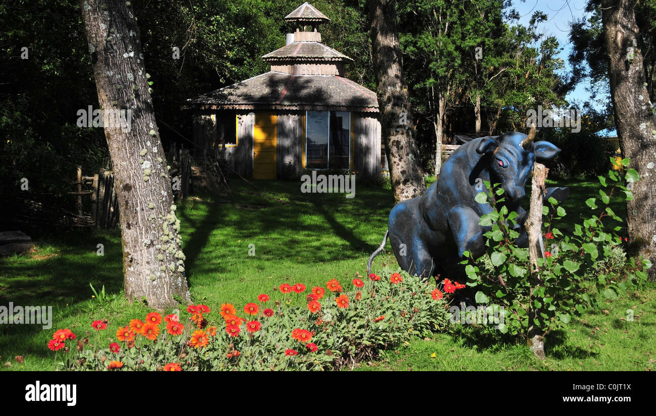 Sunny garden view of grass red flowers trees summerhouse and blue ...