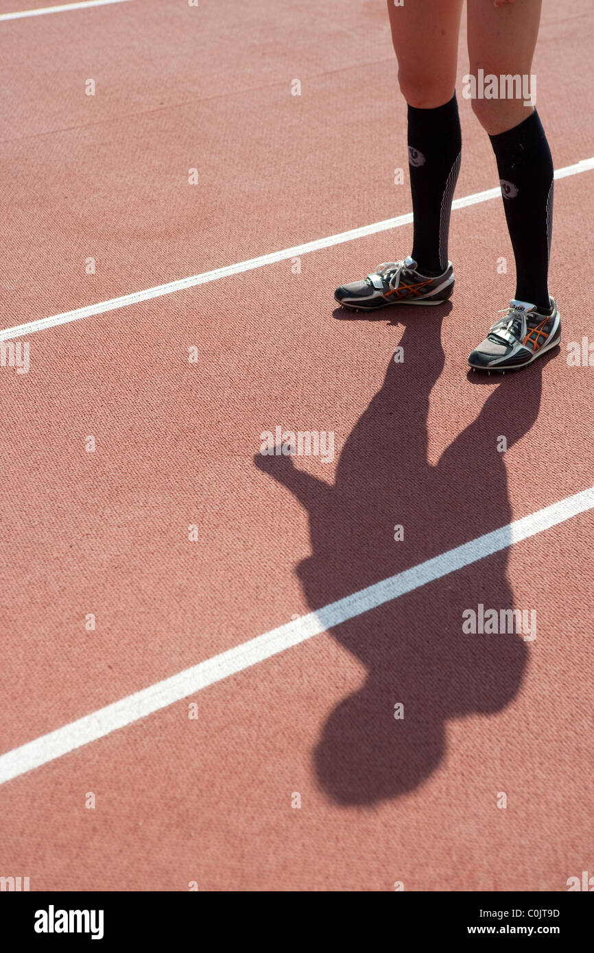 athlete legs on track and shadow Stock Photo - Alamy