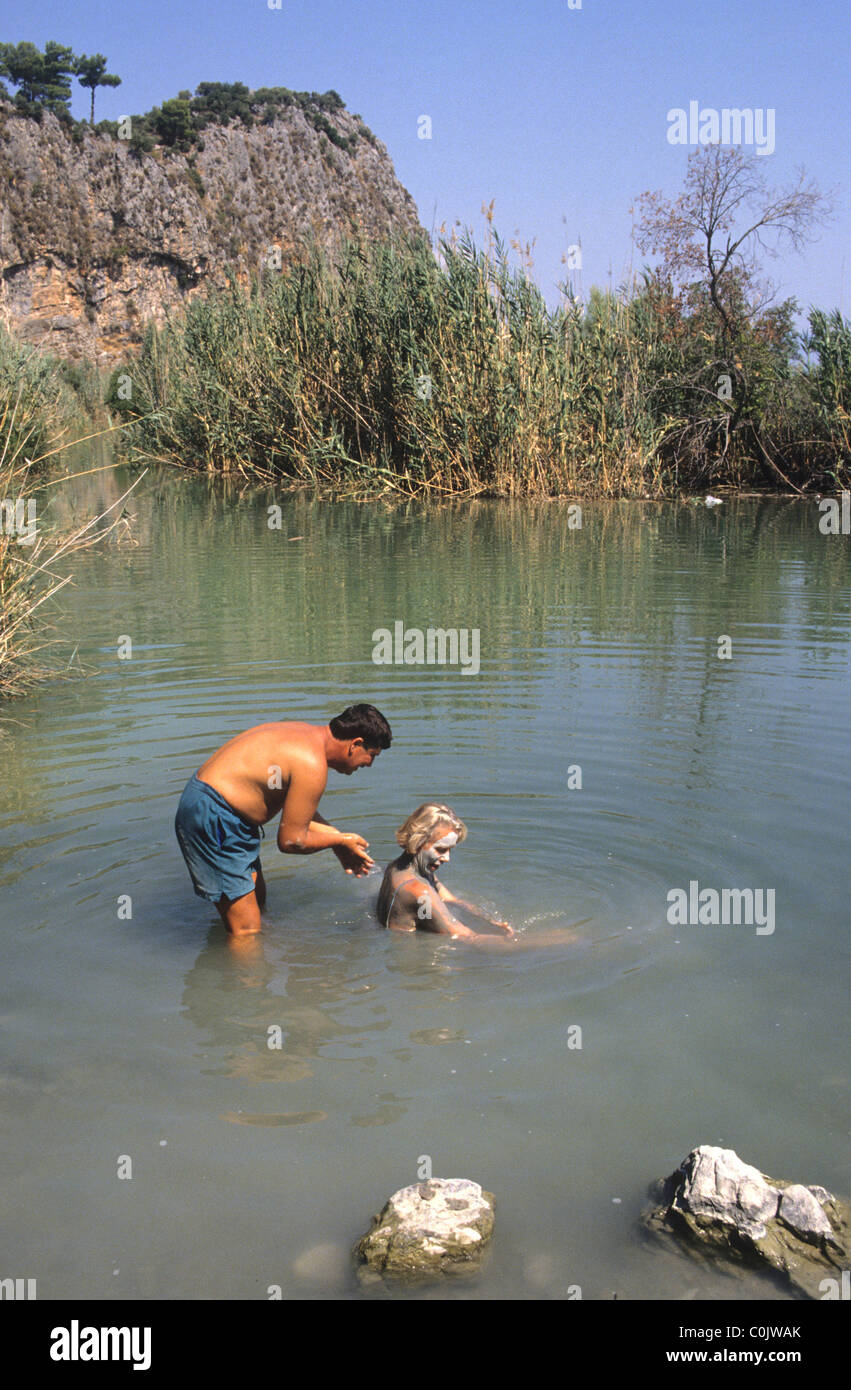 Tourists in Turkey enjoying the mud in the thermal springs near Dalyan ...