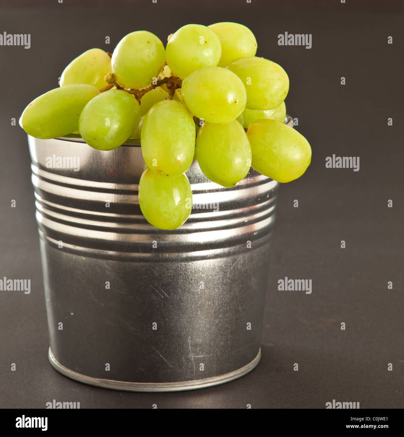 Bunch of green grapes in a tin can Stock Photo - Alamy