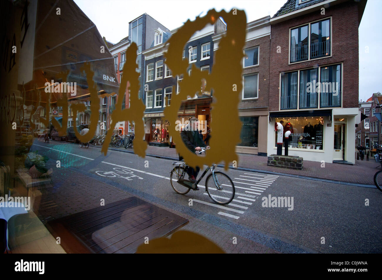 Cyclist in Amsterdam passing bar window Stock Photo - Alamy