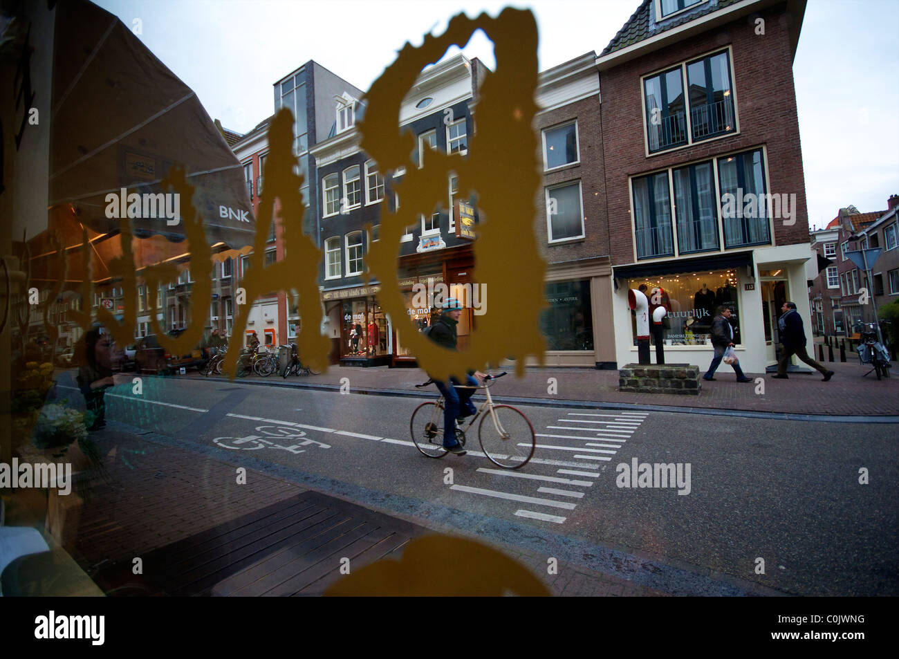 Cyclist in Amsterdam passing bar window Stock Photo - Alamy