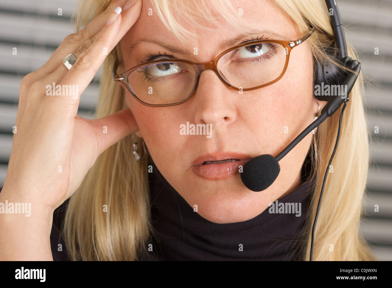 Phone Operator with phone headset show signs of having a headache Stock ...