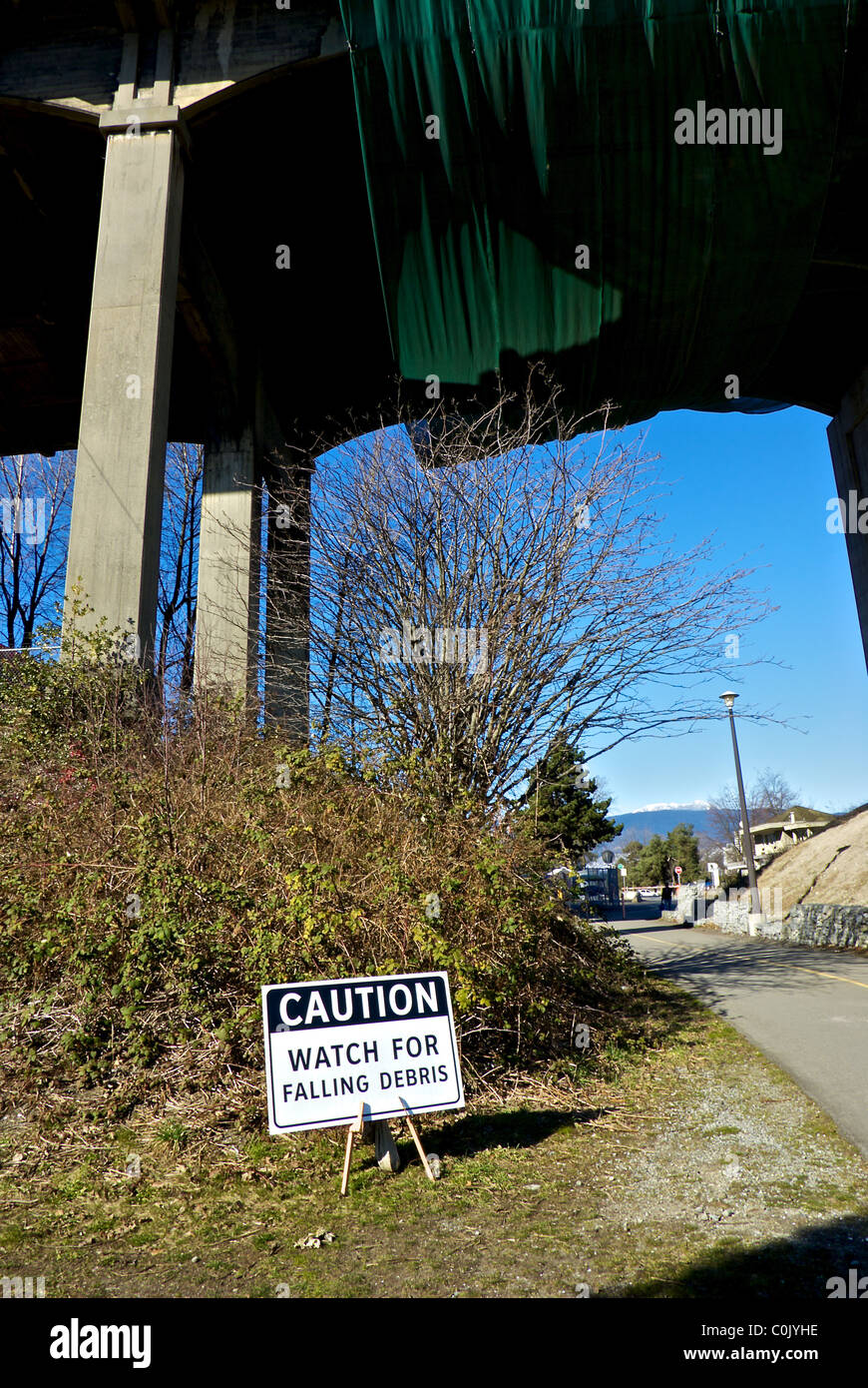 Warning sign to watch for debris falling from safety net below old ...