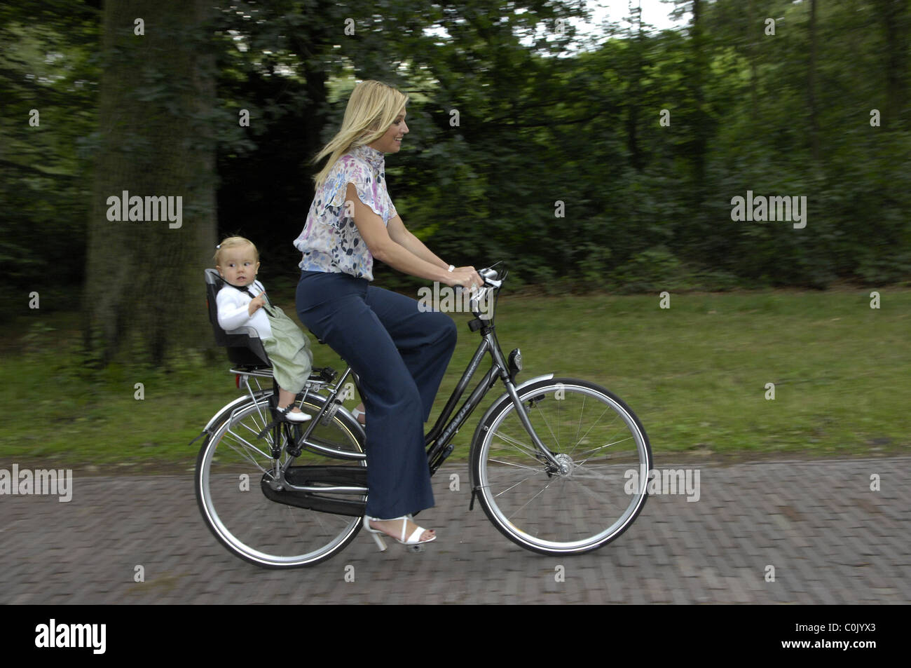Princess Maxima and Princess Ariane of the Netherlands ride a bike ...