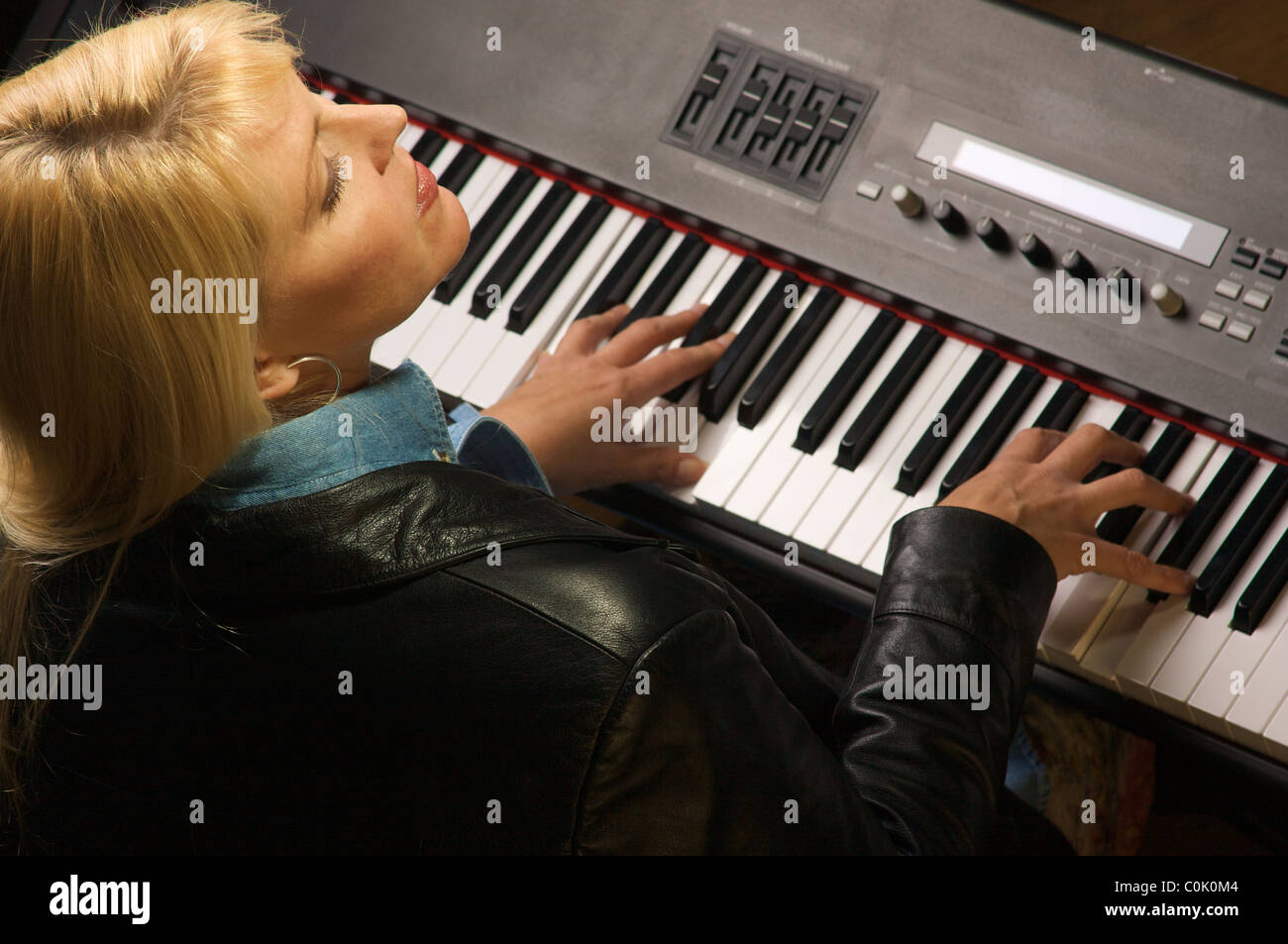 Female Musician Sings While Playing Digital Piano Stock Photo - Alamy