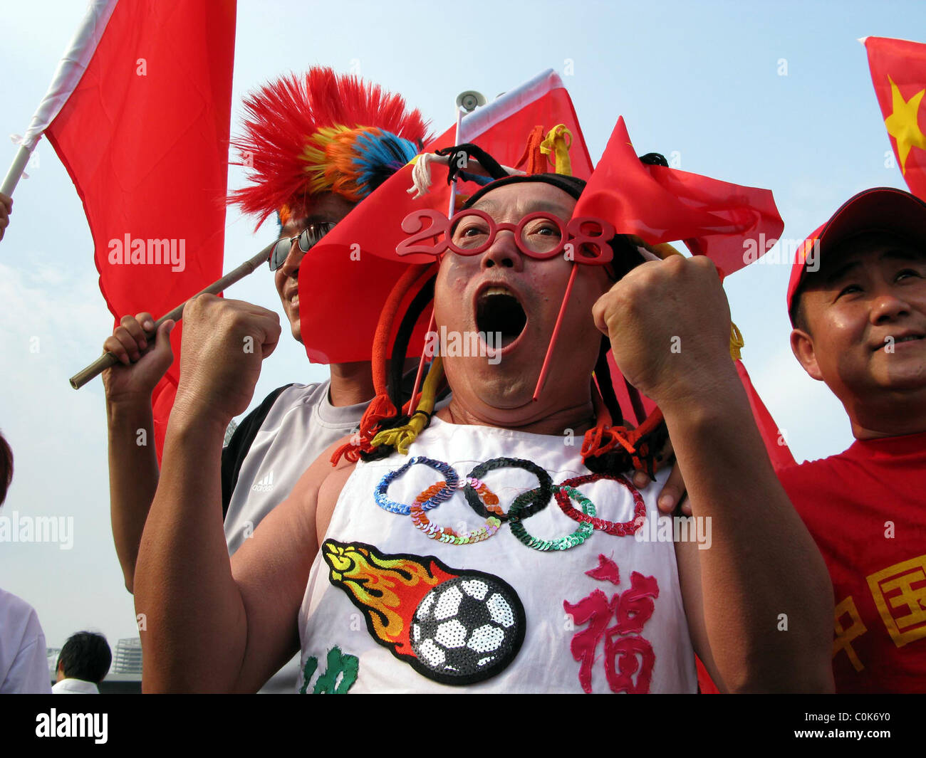 Chinese fans wearing fancy dress outside Shenyang Olympic Stadium ahead ...