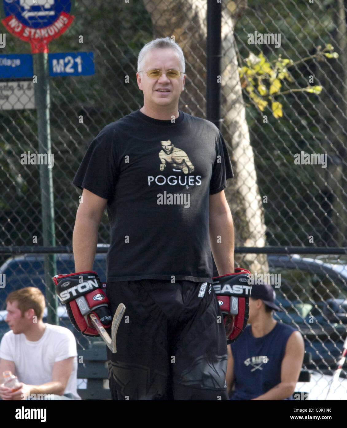 Tim Robbins enjoys a game of roller hockey, stopping to pose for a ...