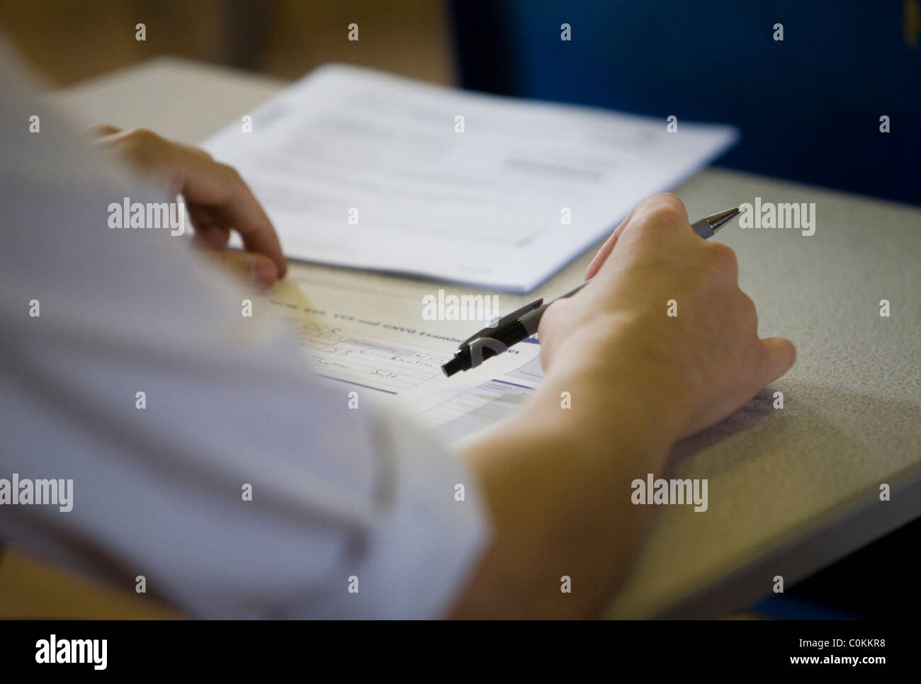 A pupil fills in an answer booklet of a GCSE exam at Maidstone Grammar ...