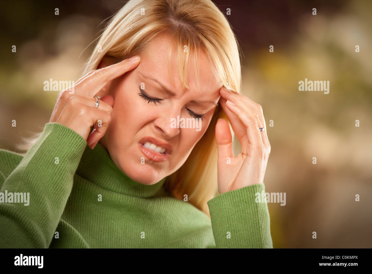 Grimacing Woman Suffering a Painful Headache Stock Photo - Alamy