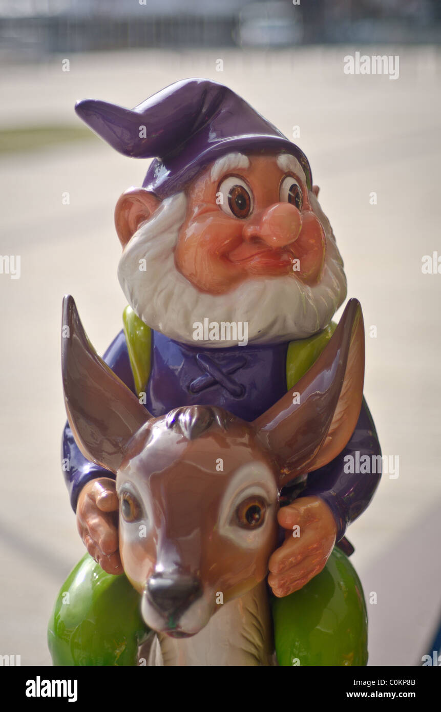 Dwarf sitting on deer child's ride Stock Photo - Alamy